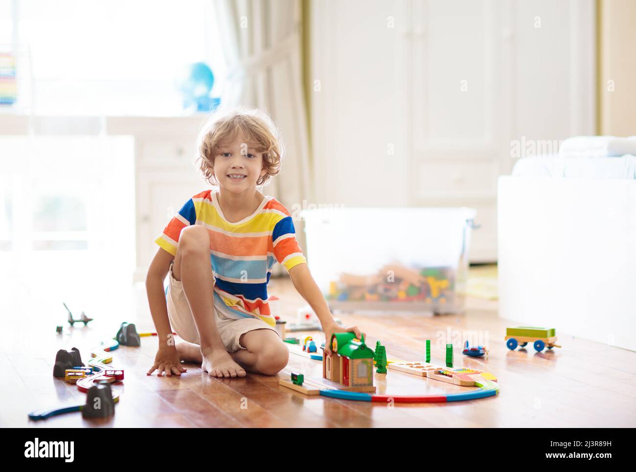 Kids play with wooden railway. Child with toy train. Educational toys ...