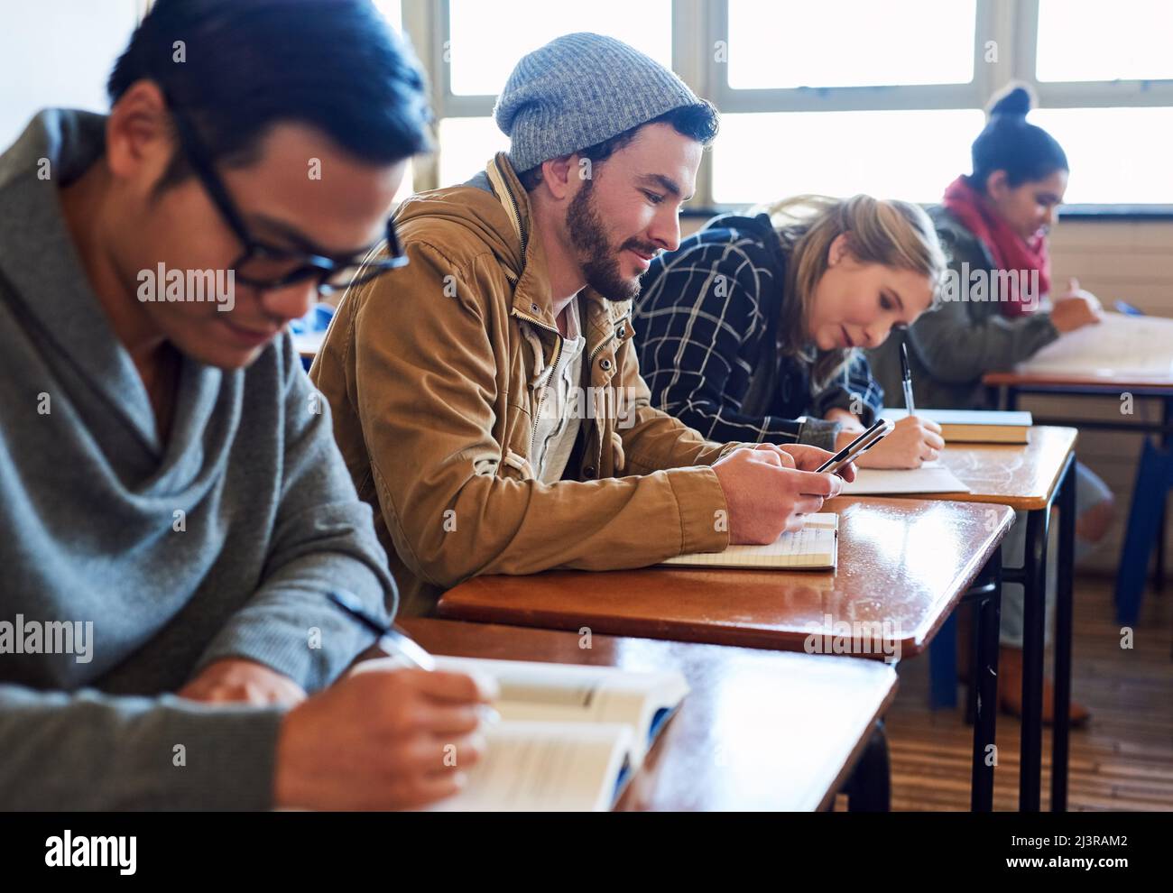 Sending texts during class hi-res stock photography and images - Alamy