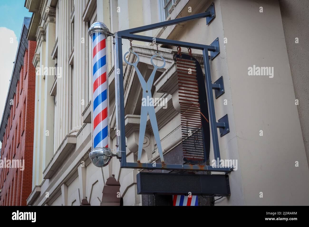 Barbers Pole and sign, scissors and comb Stock Photo - Alamy