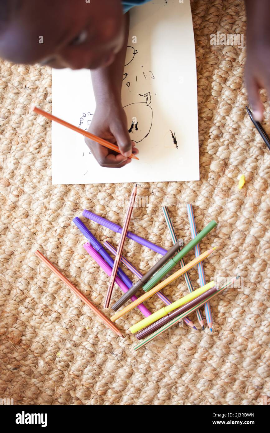 Mom and dad got me so many new colours. Shot of a young boy sitting on ...