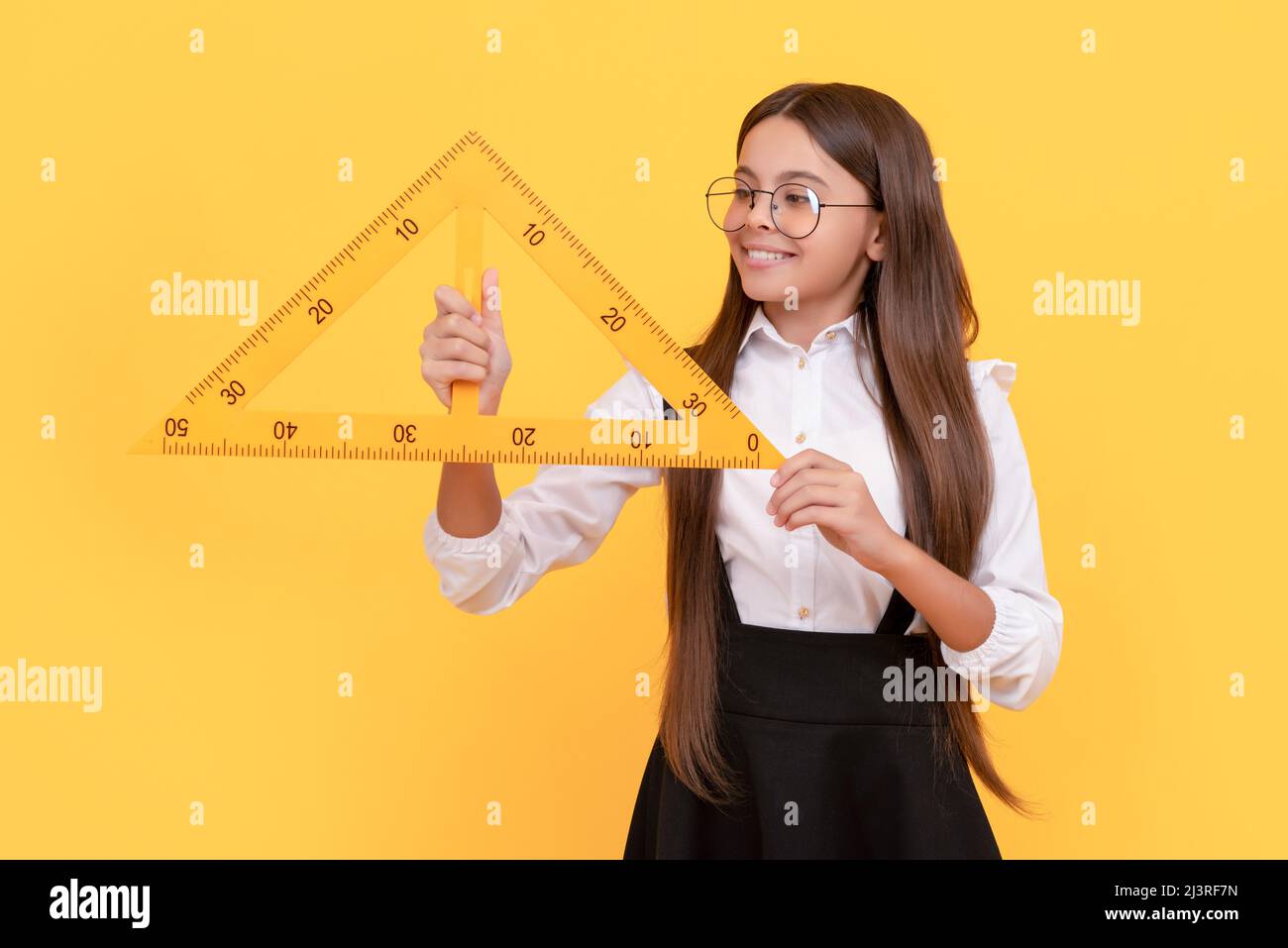 mathematics. happy teen girl hold triangle. back to school. algebra and ...