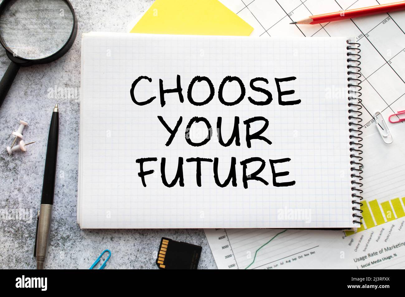 Card with text CHOOSE YOUR FUTURE on the pen box in the office. Diagram ...