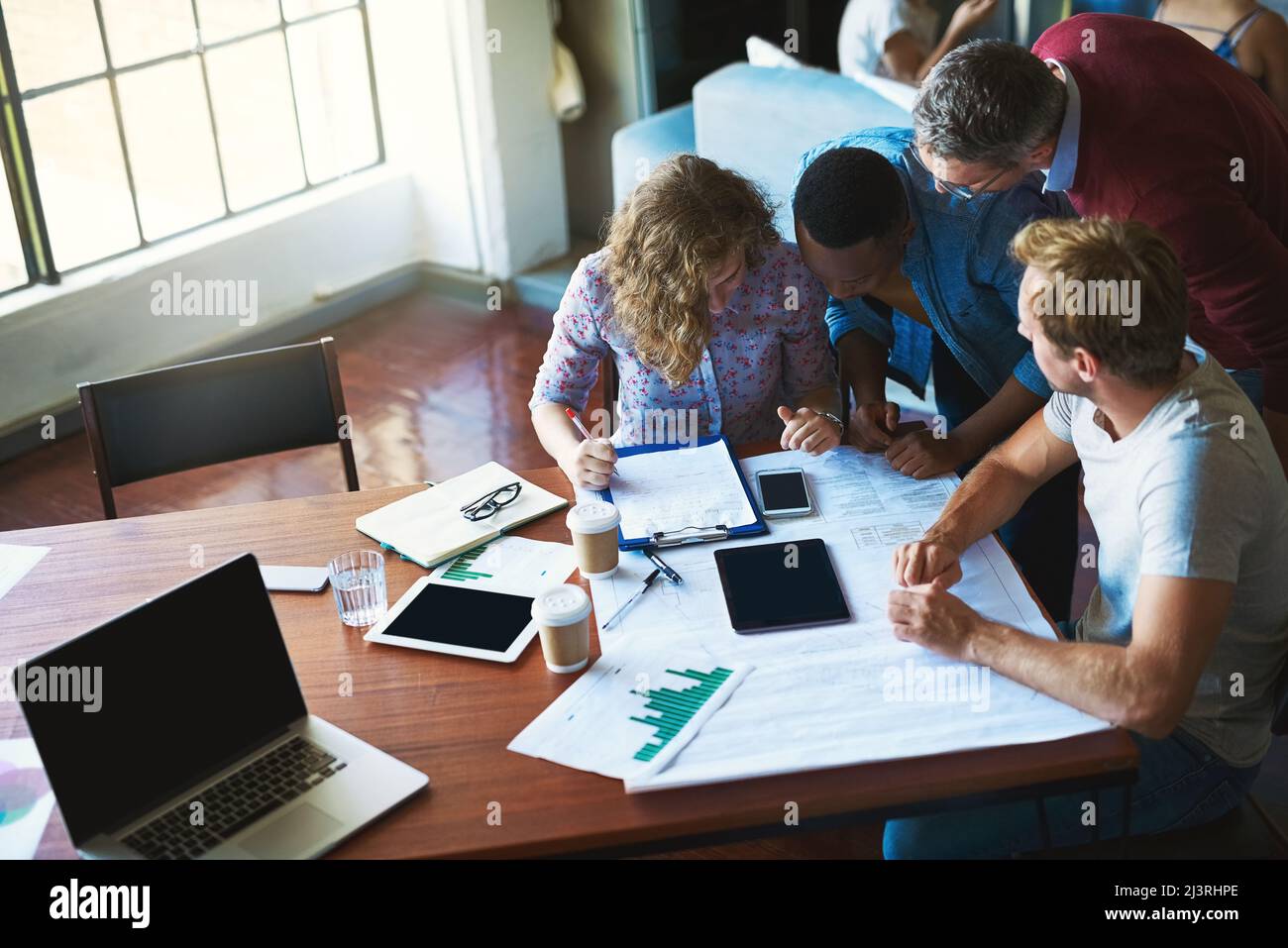Teamwork is the best way have a productive workday. Shot of a diverse ...