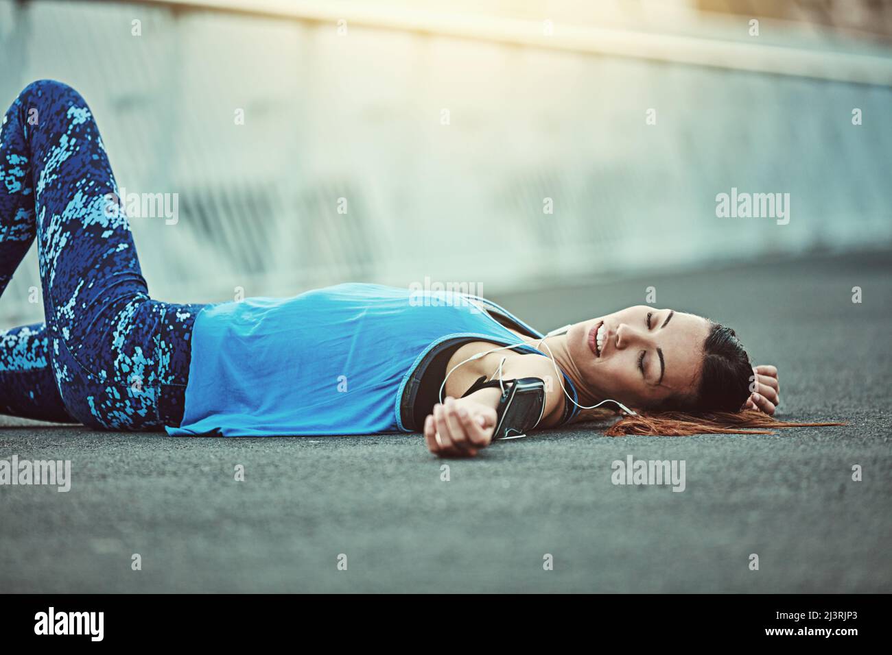 Pain never felt this good. Shot of a young woman looking exhausted ...