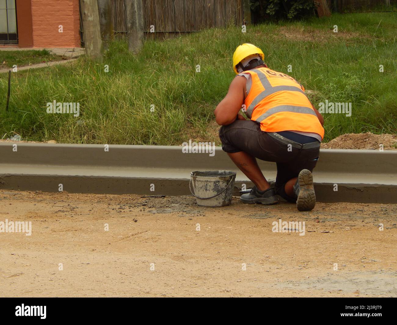 Construction workers with yellow helmet and orange safety vest building ...