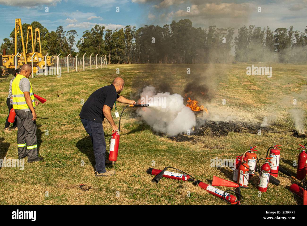 Training workers in fire fighting Stock Photo - Alamy