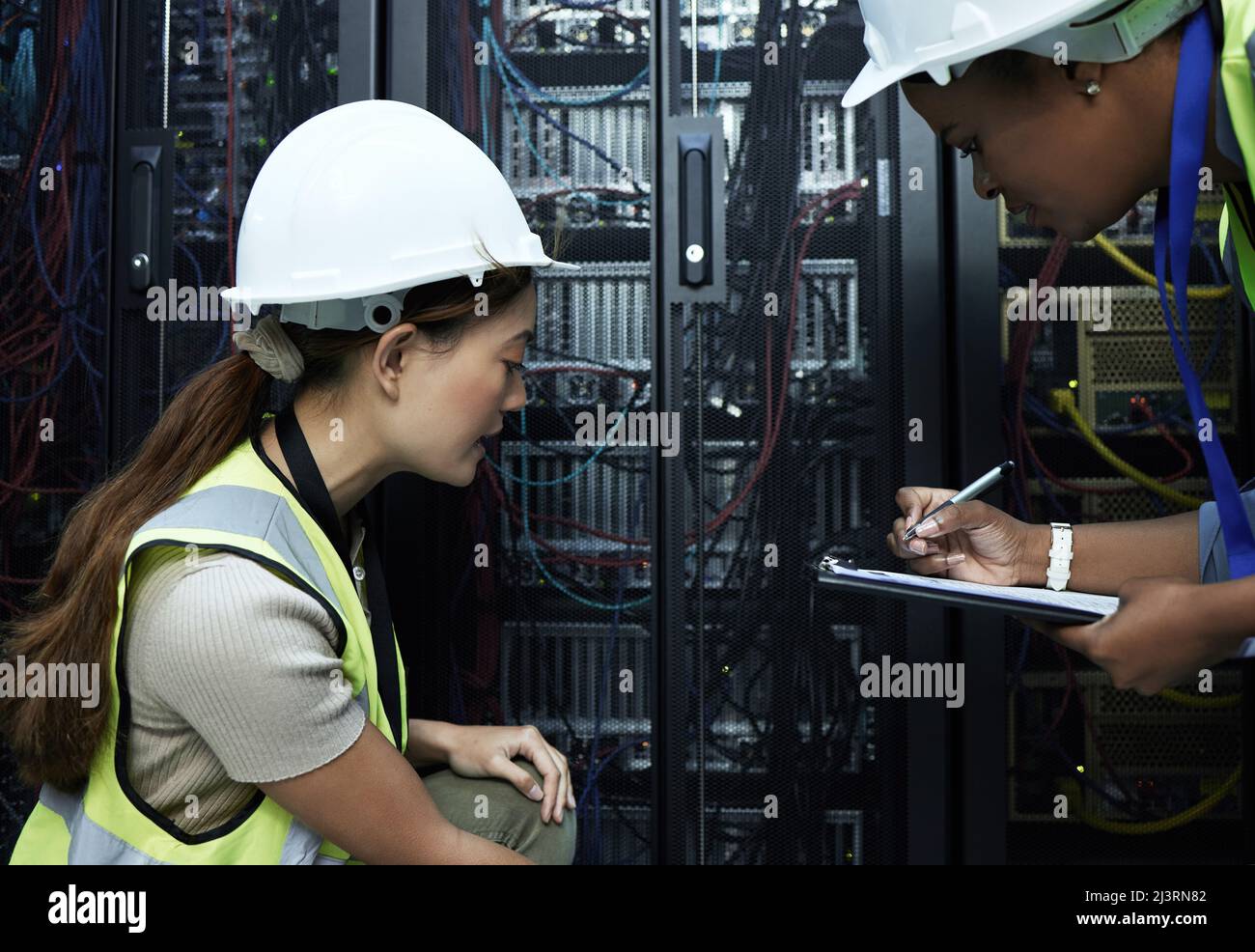 Lets make a note and come back to it. Cropped shot of two attractive ...