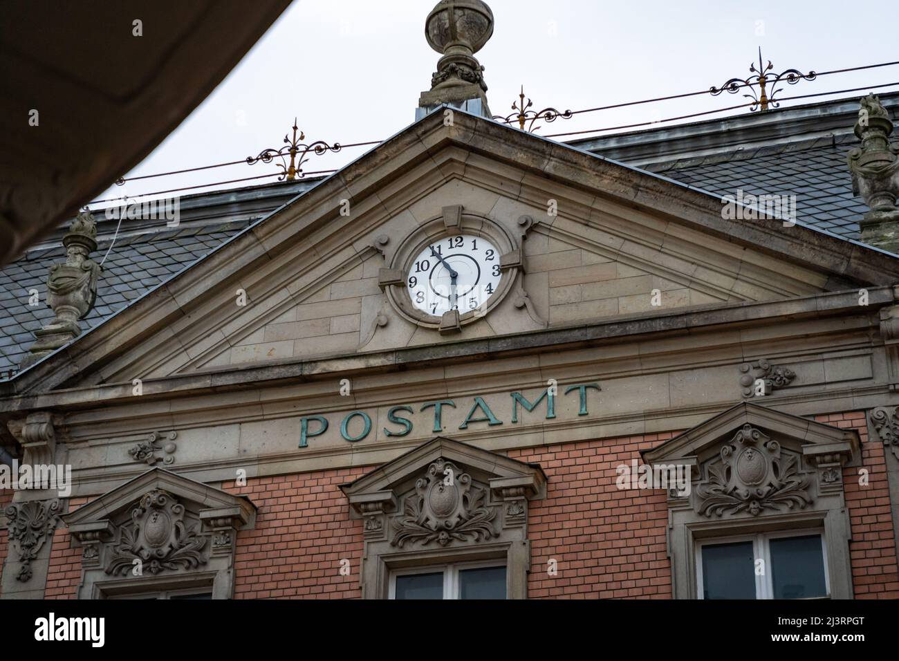 The post office in the city with the lettering Postamt on the facade. A ...