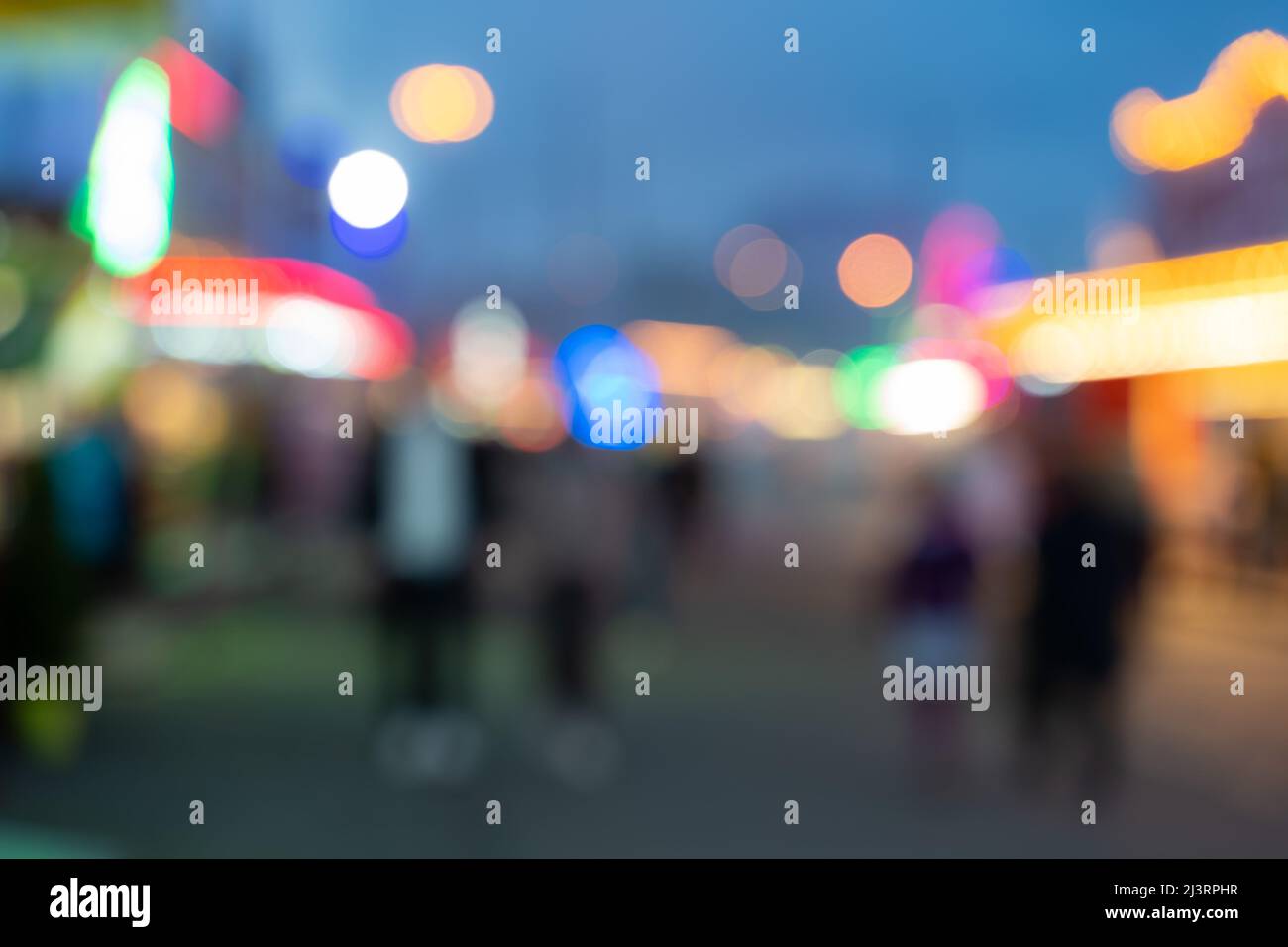 Blurred fairground background with many shining lights. Blurry funfair ...