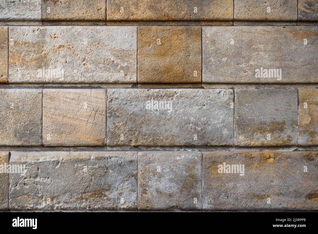 Massive stone wall made of sandstone blocks. Building exterior of an ...