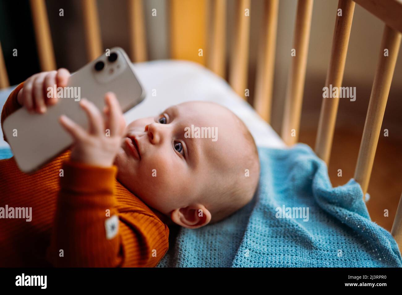 Baby toddler holding smartphone. Watching a video on smartphone Stock ...