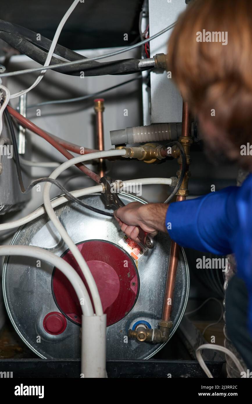 He knows those pipes like the back of his hands. Cropped shot of a ...