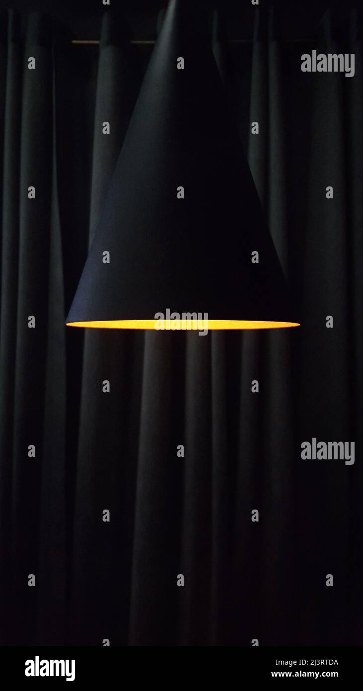 Modern lamp against the background of the folds of curtains in dark ...
