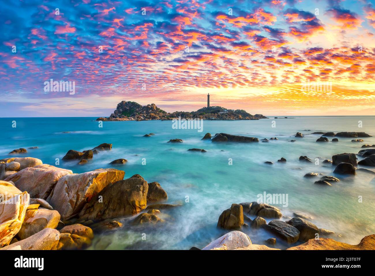 Landscape of the small island with the ancient lighthouse at sunset sky ...