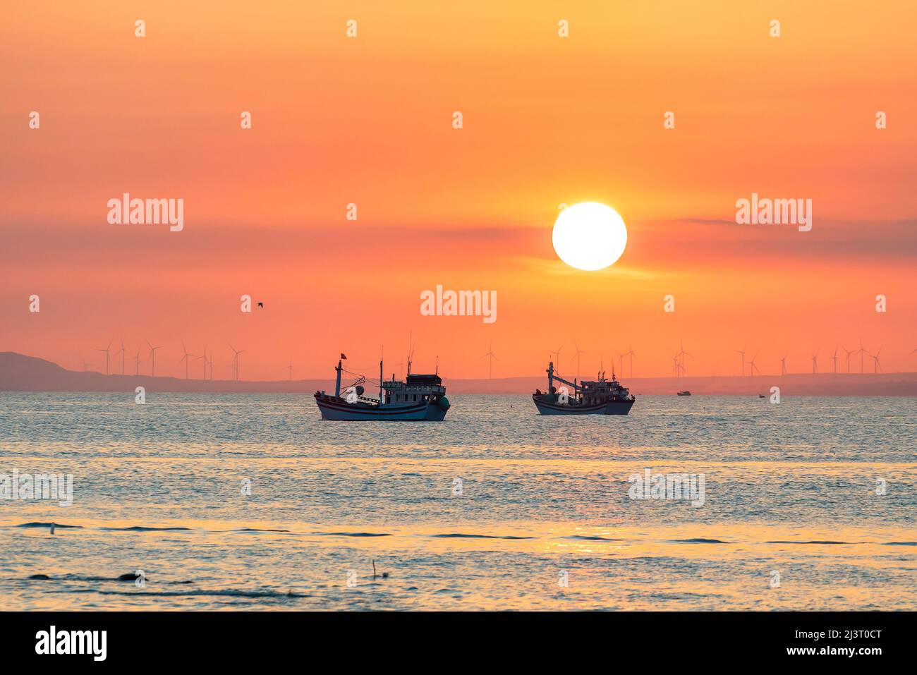 Sunset landscape when fishing boats out to sea to harvest fish end the ...