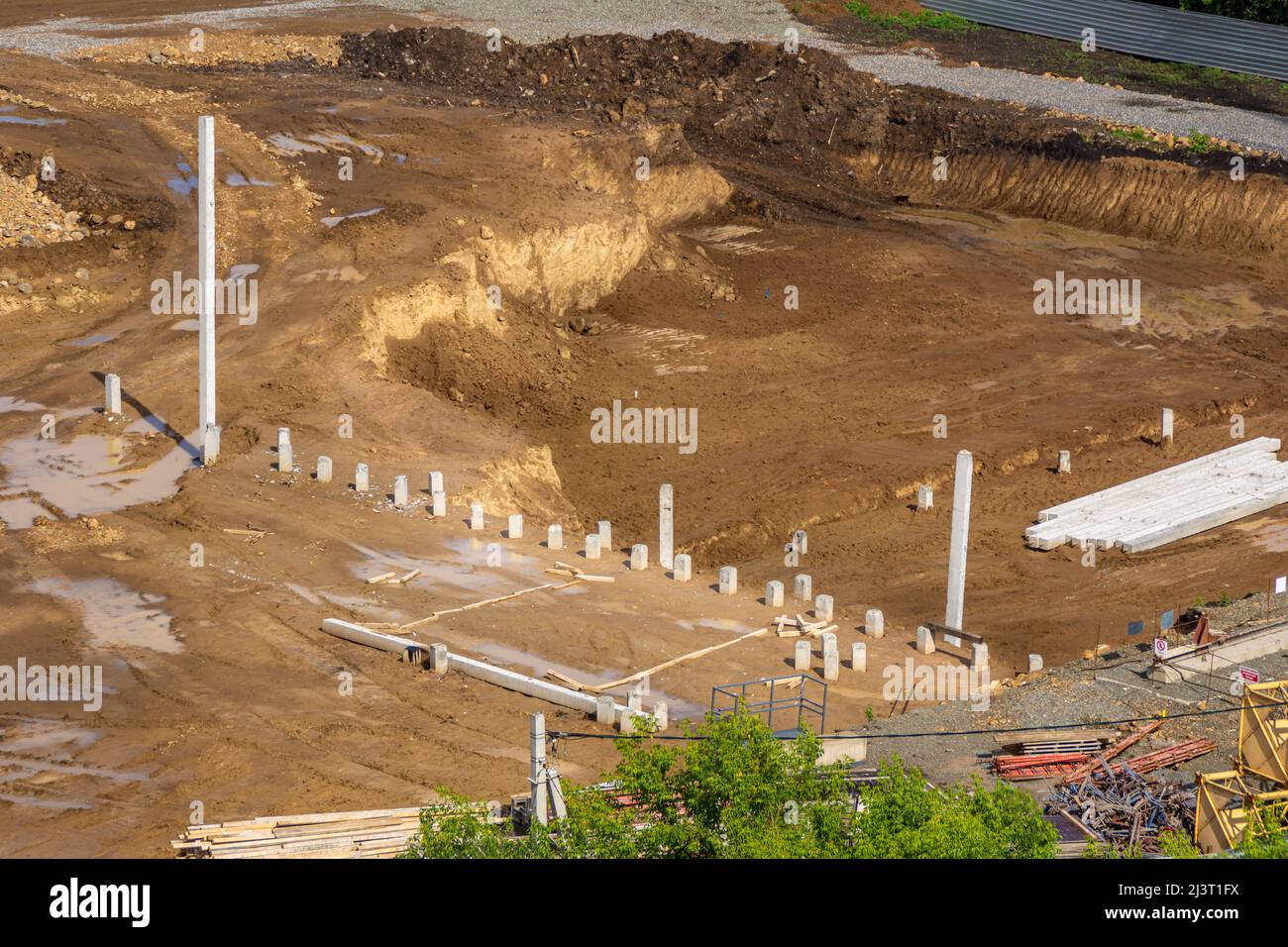 construction site with a foundation pit of complex shape with several ...