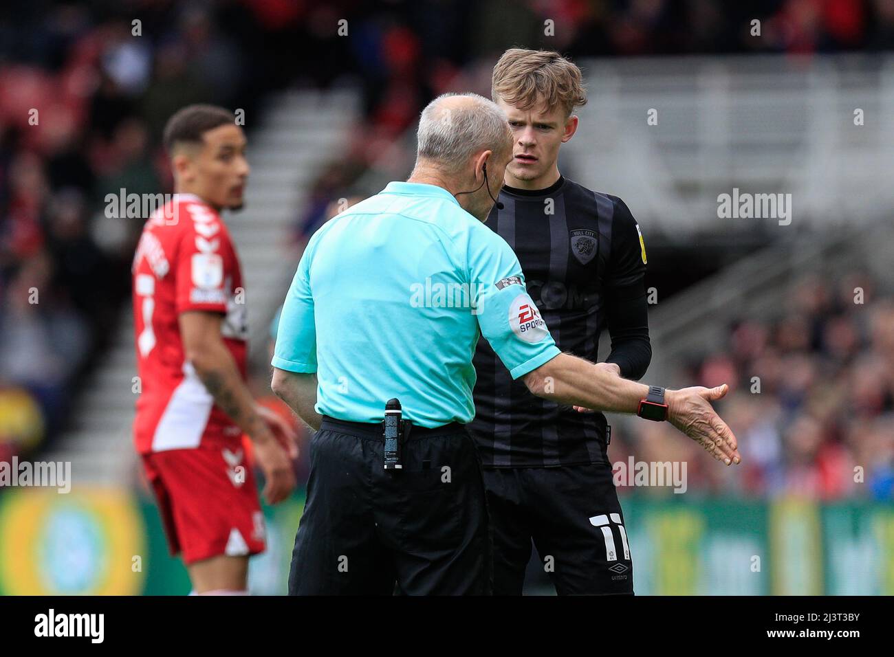 Referee Andy Woolmer speaks with Keane Lewis-Potter #11 of Hull City ...