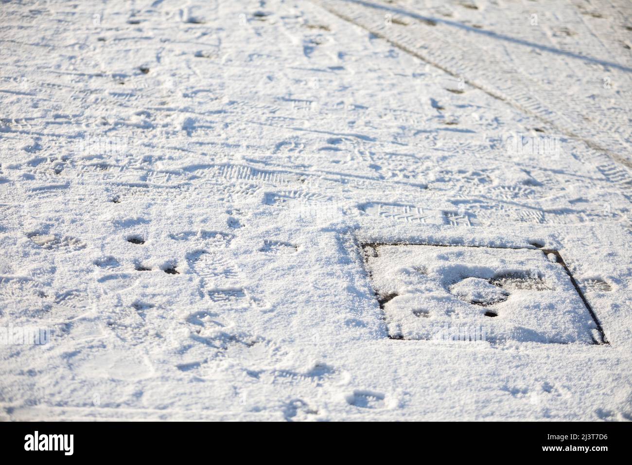 A completely snow covered sidewalk on a city housing project. Shoe ...