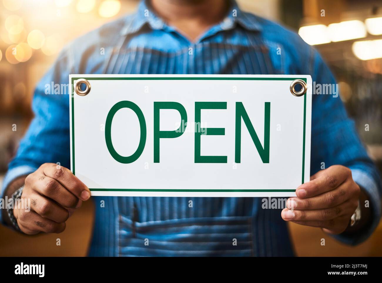 Its official - we just opened. Closeup shot of an unrecognizable man ...