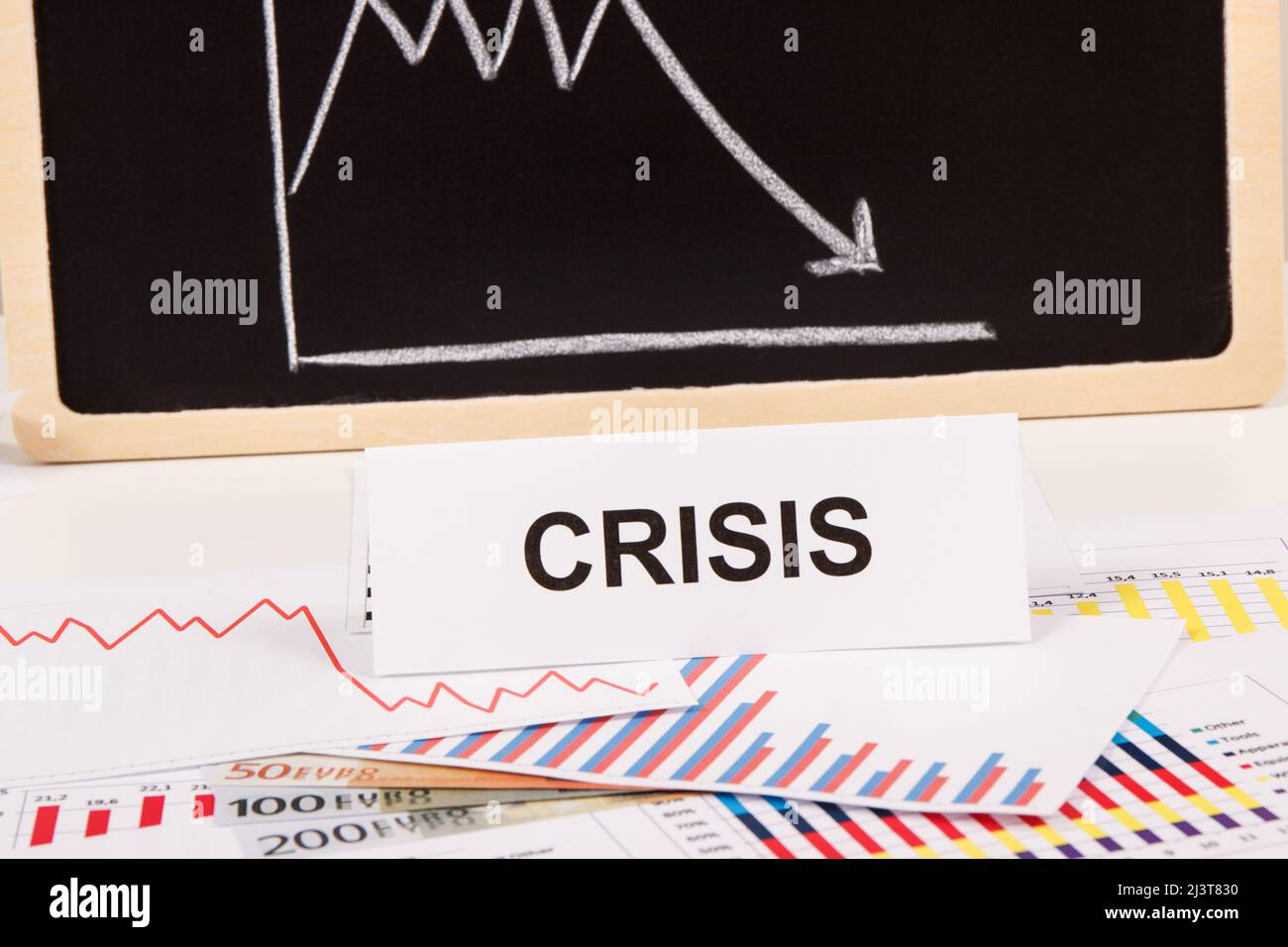 Currencies euro and downward graphs representing financial crisis ...