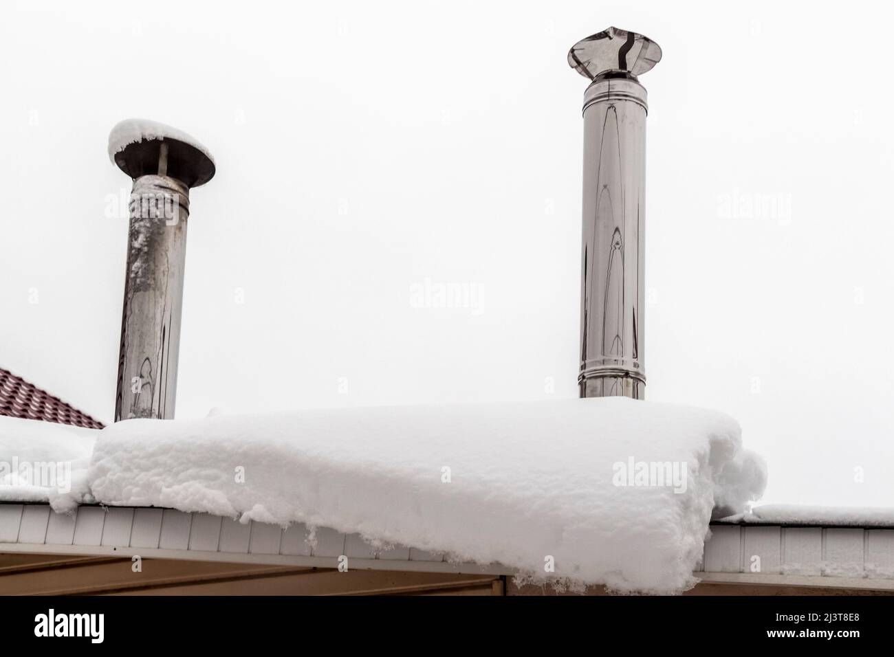 Chimney on a snowy roof of a private home Stock Photo - Alamy