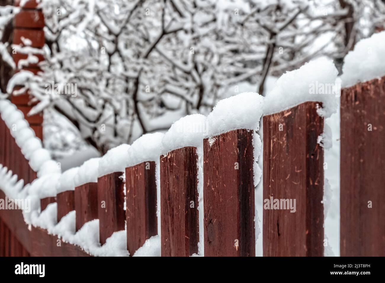 Rural wooden fence covered with freshly fallen snow Stock Photo - Alamy