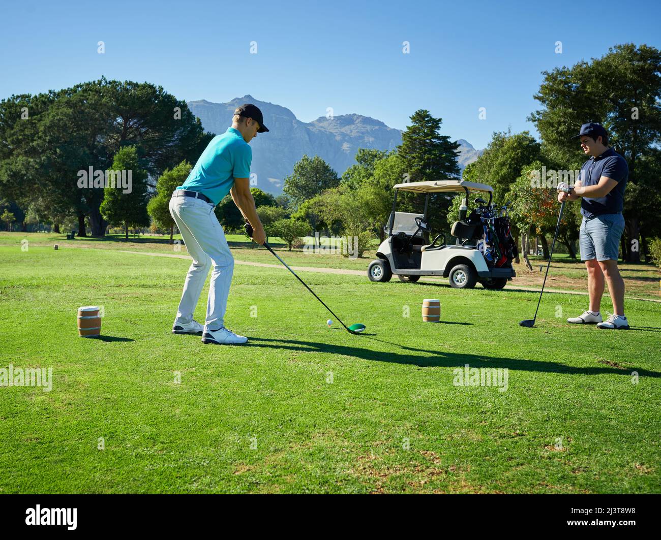 A good posture makes for a good swing. Shot of two focused young men ...