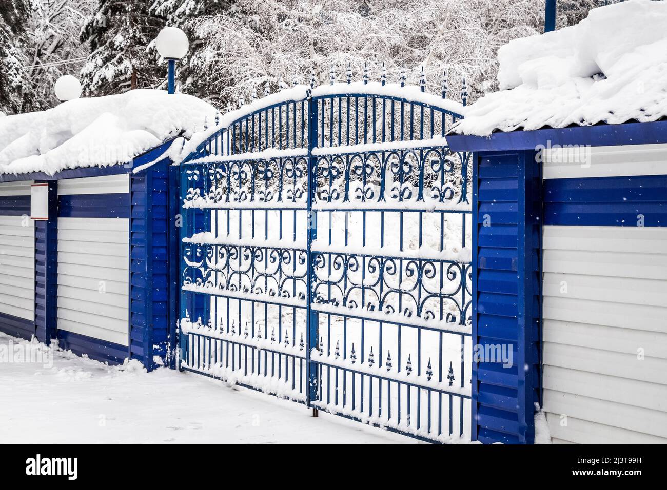 Blue metal entrance gate to the yard Stock Photo - Alamy