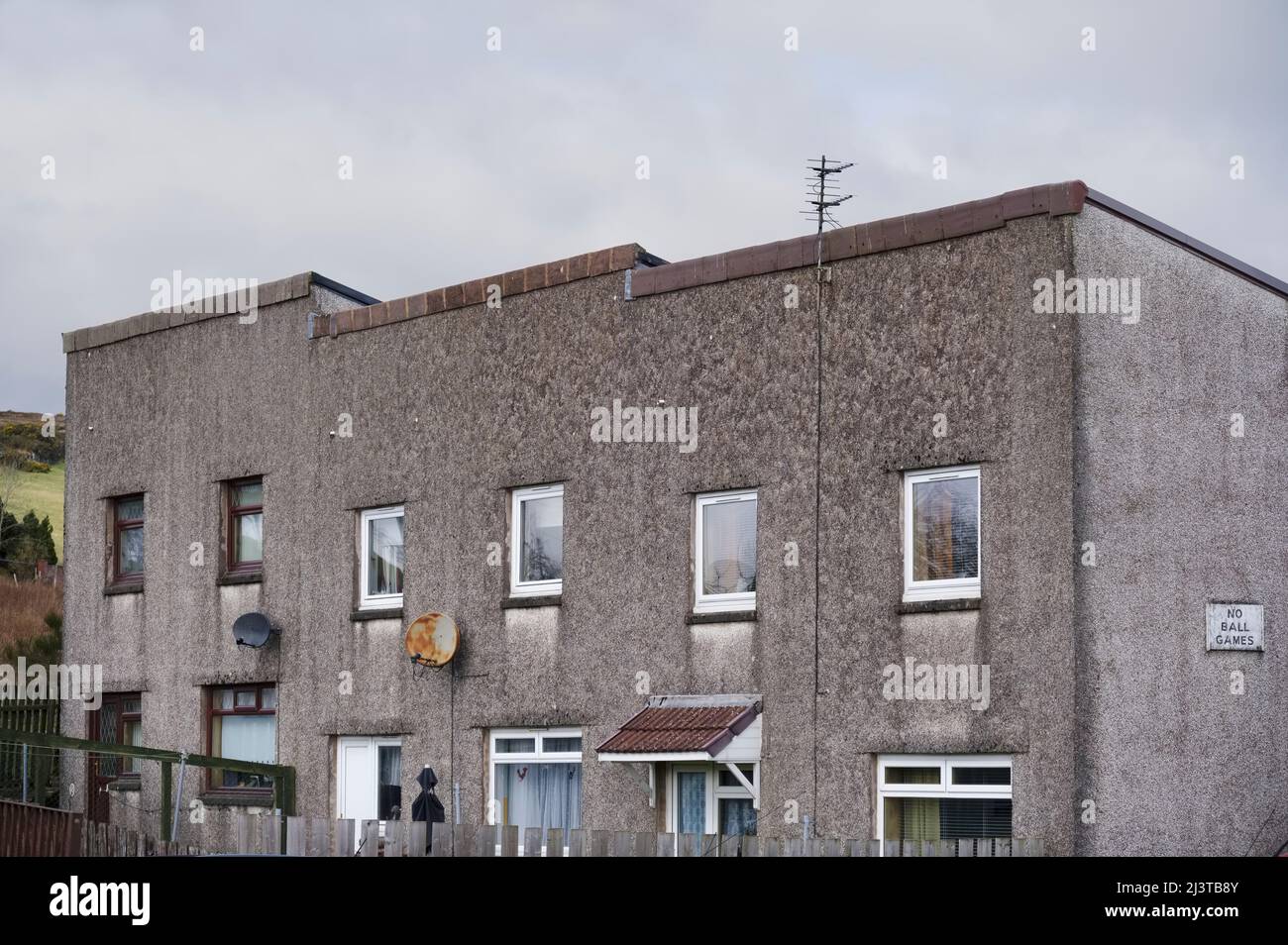 Derelict council house in poor housing estate slum with many social ...