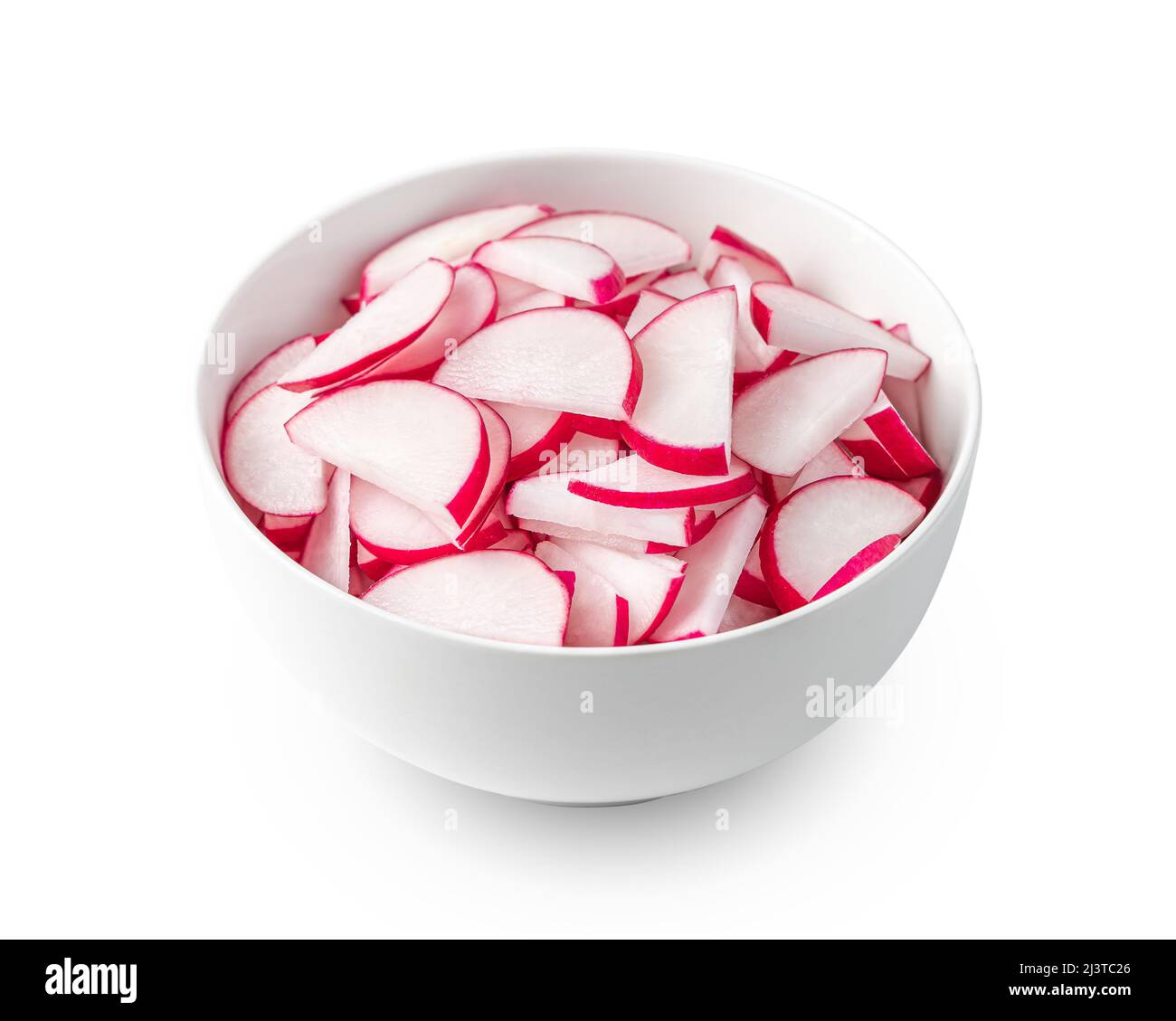 Radish cut into thin slices in a bowl is isolated on a white background ...