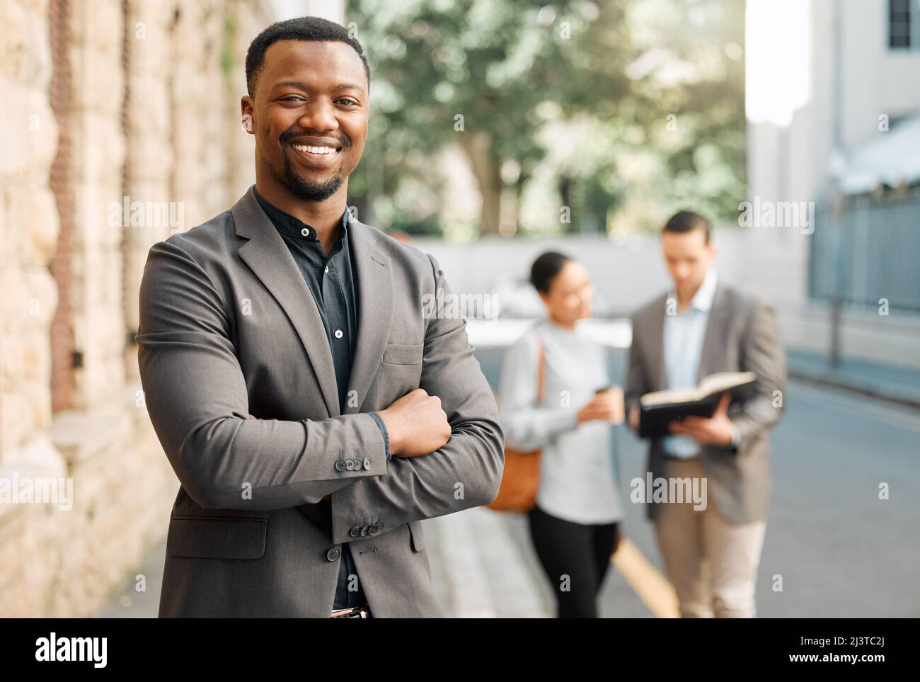Proud of my career. Shot of a young businessman walking to work with ...