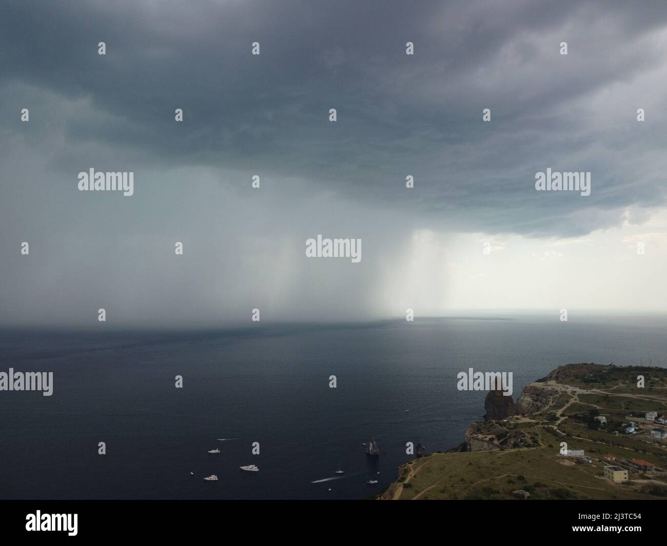 Aerial view footage of rain clouds over sea ocean Black clouds in bad ...