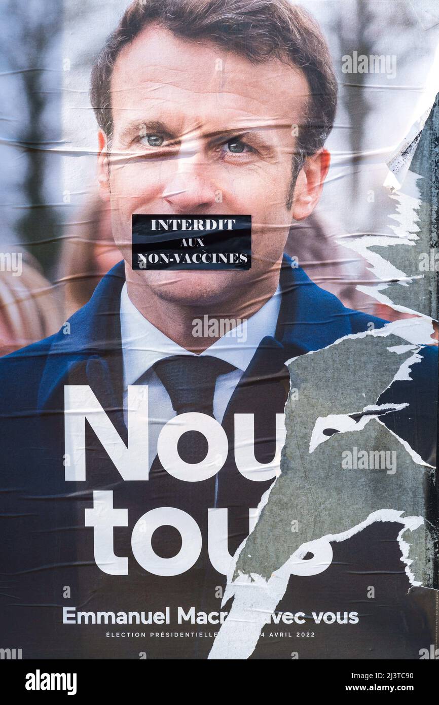 Poster of Emmanuel Macron with a sticker on the mouth saying "Forbidden ...