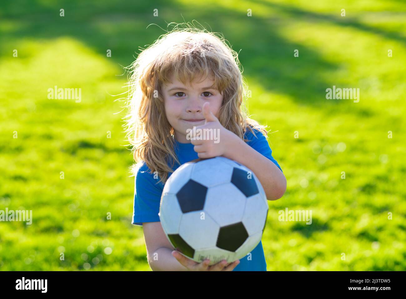 Boy holding soccer ball, close up sporty kids portrait. Soccer boy show ...