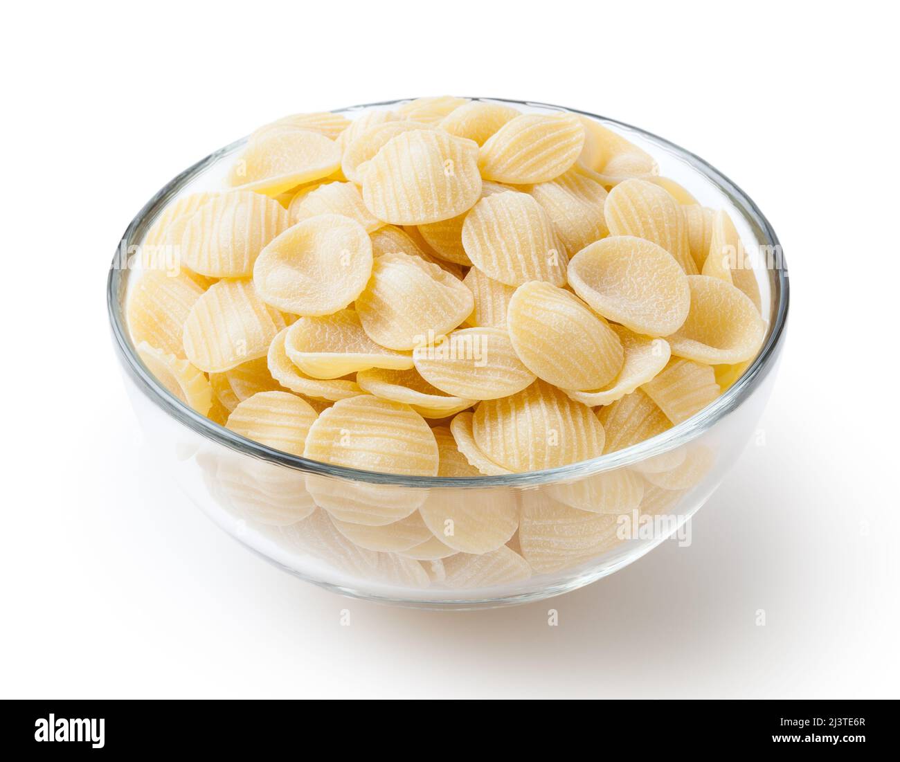 Uncooked orecchiette pasta in glass bowl isolated on white background ...
