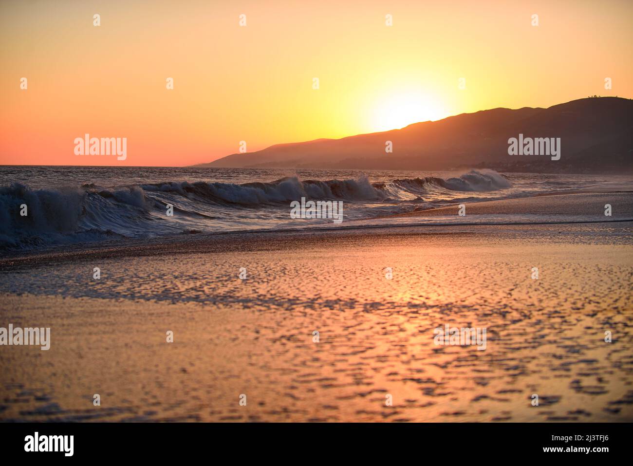 Sunset with large yellow sun under the sea surface. Calm ocean with ...