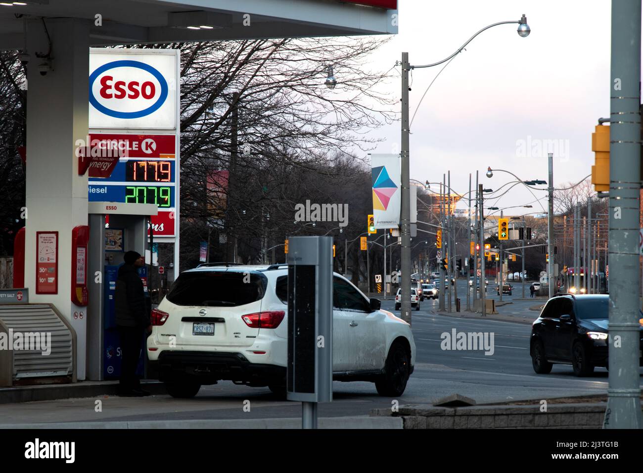A man is seen parked, filling up with gas in downtown Toronto as gas ...