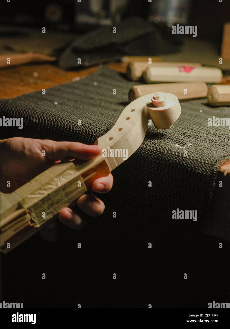 artisan sculpting a violin scroll - luthier at work concept Stock Photo ...