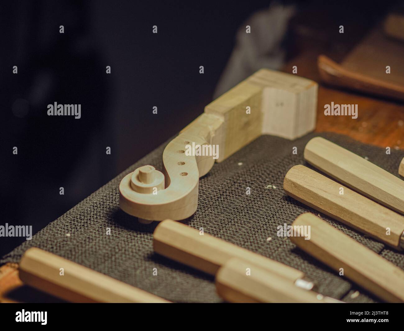 artisan sculpting a violin scroll - luthier at work concept Stock Photo ...