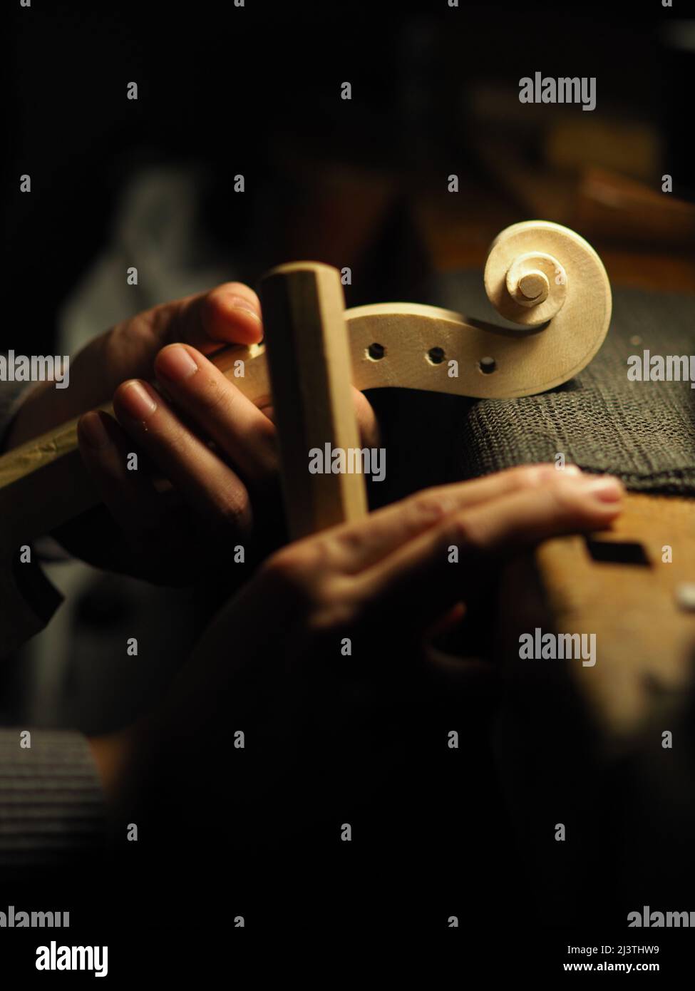 artisan sculpting a violin scroll - luthier at work concept Stock Photo ...