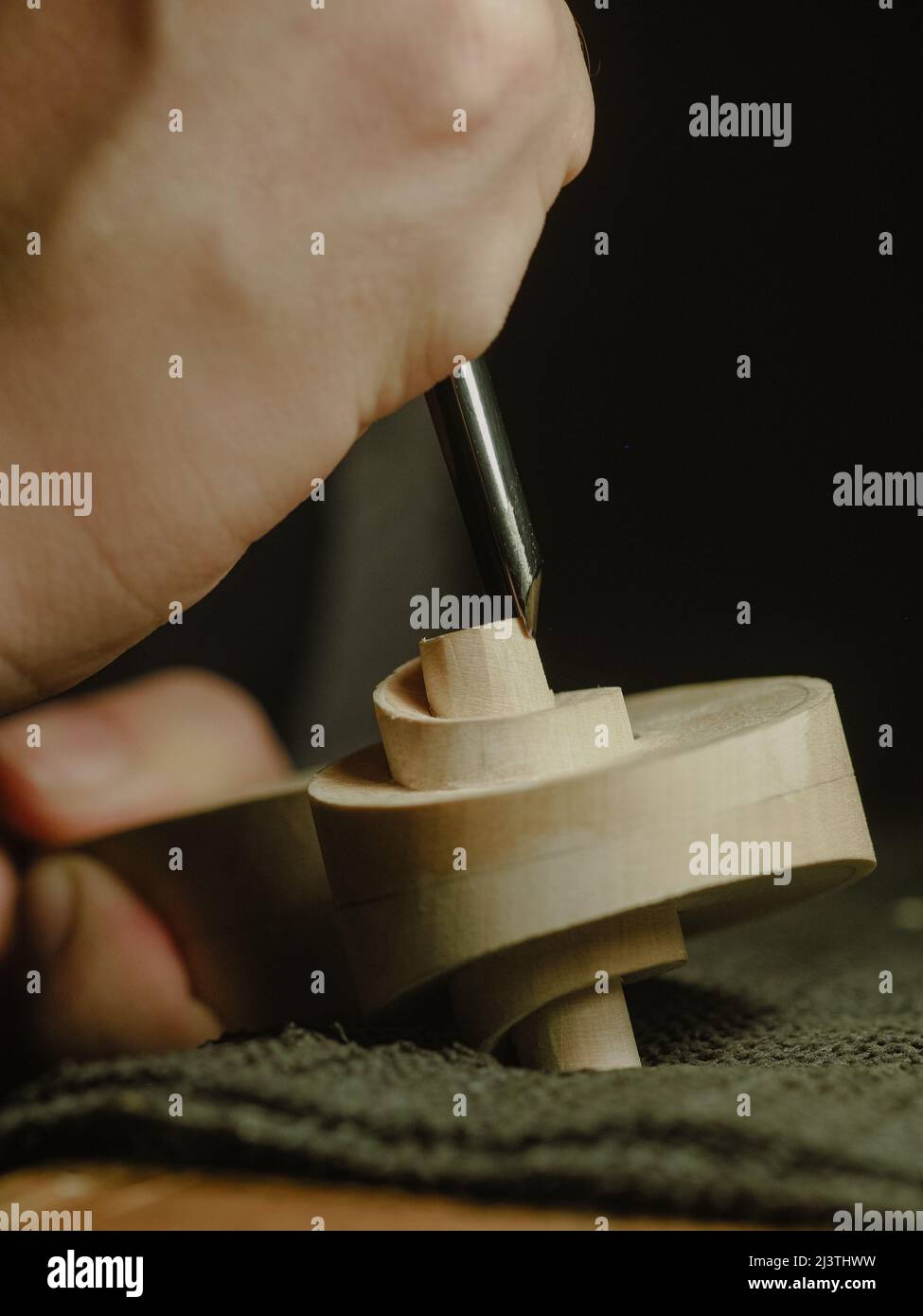 artisan sculpting a violin scroll - luthier at work concept Stock Photo ...