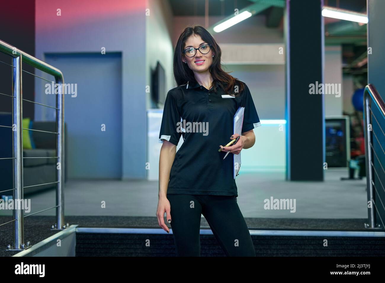 Shall we get started. Portrait of a young personal trainer standing in ...