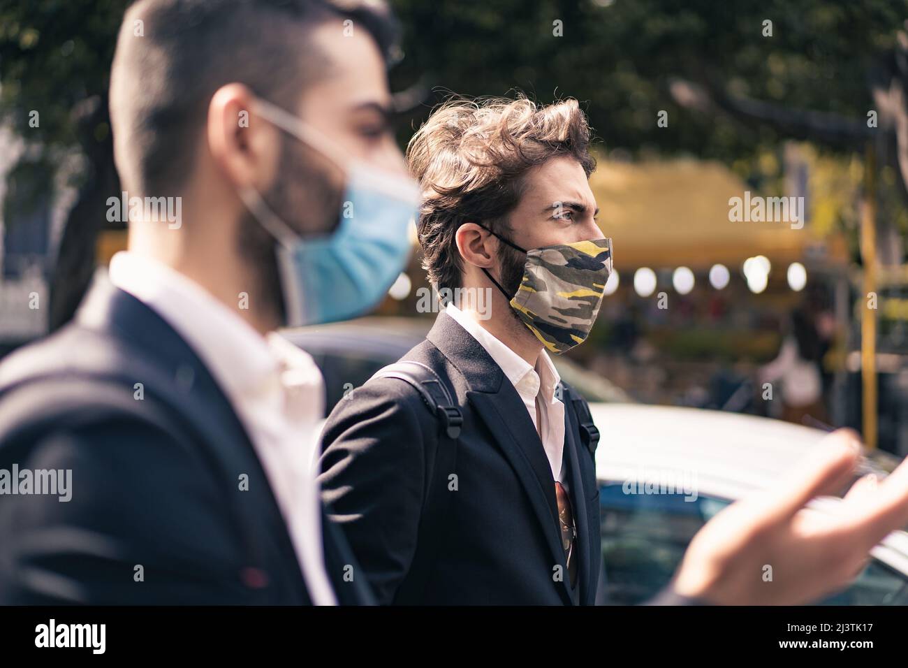Profile portrait of young people in suit with face masks Stock Photo ...