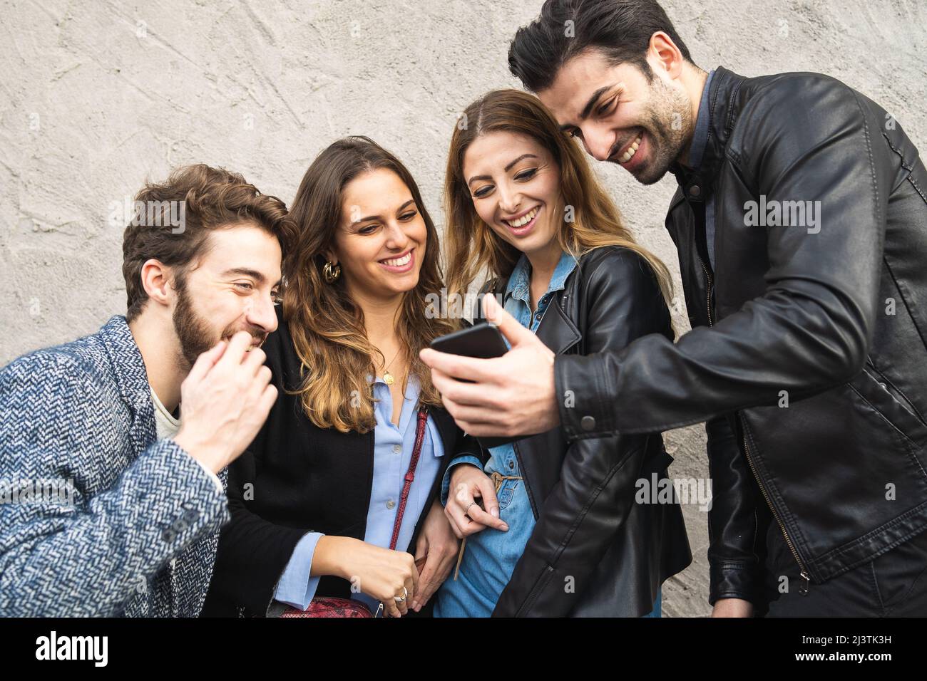Group of young people are having fun watching video content on social ...