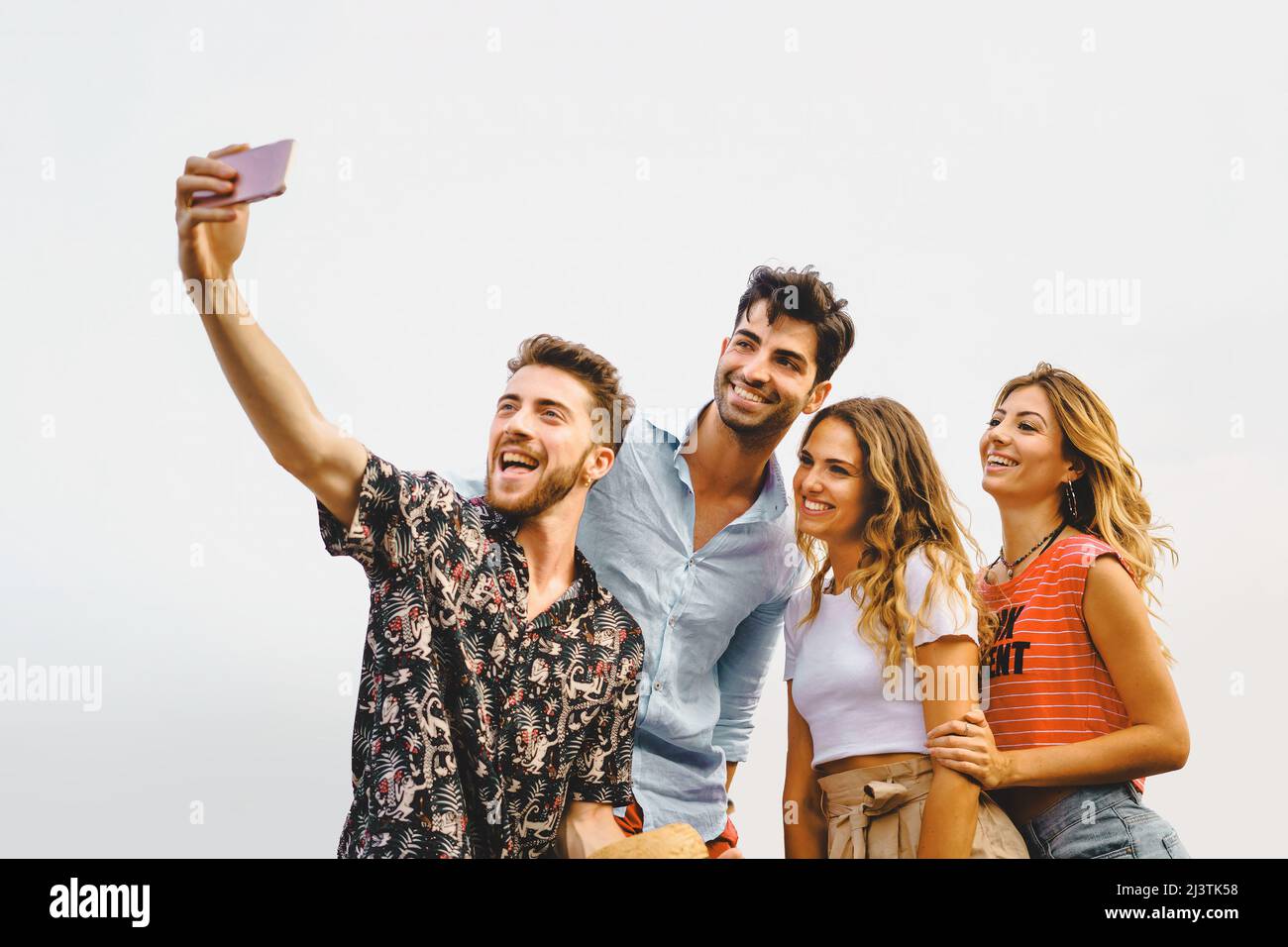 reunion gathering of generation z people having fun taking smartphone's ...