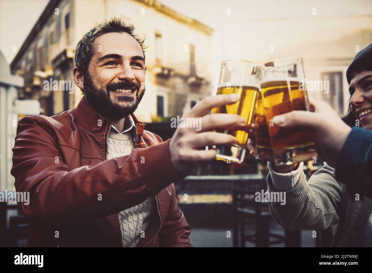 Group of people having fun toasting beers outdoors - friendship ...