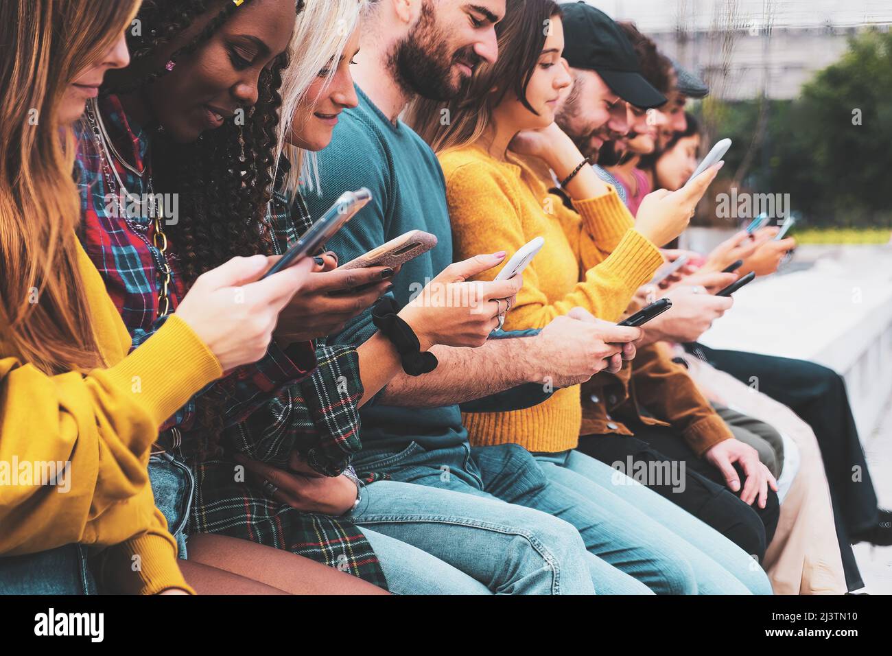 Closeup group of interracial gen z hipsters friends Sitting outdoors ...