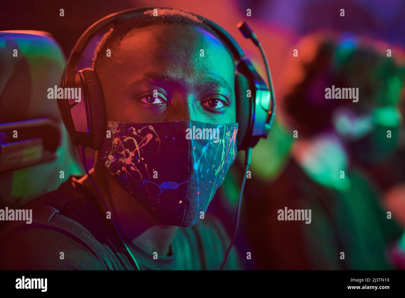 Portrait of young African-American esports gamer in headphones and ...