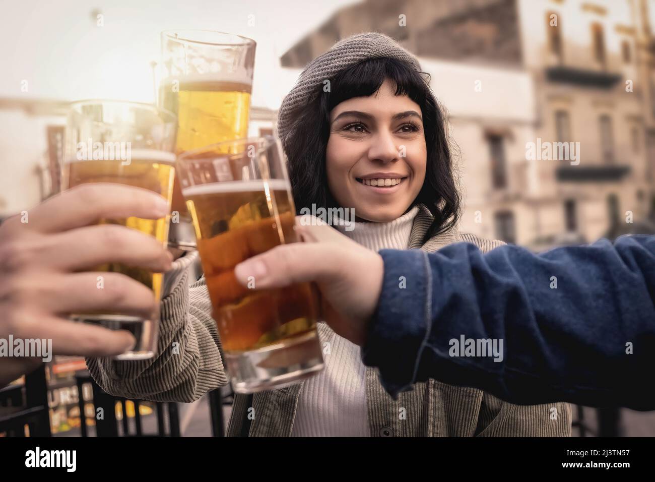 Happy young people gathering at outdoors pub toasting with beers Stock ...