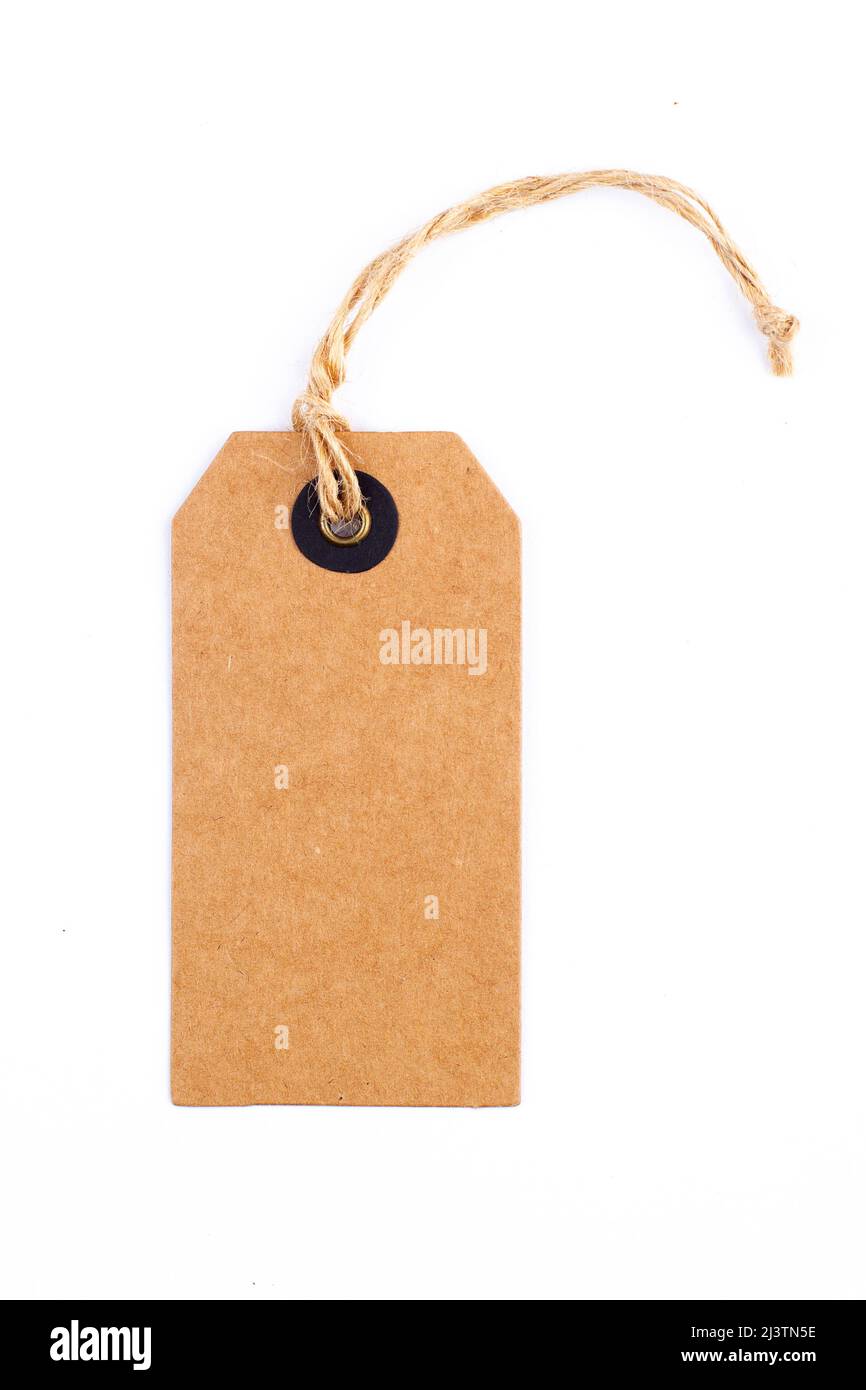 top view closeup of vintage blank craft paper tag with textile thread ...